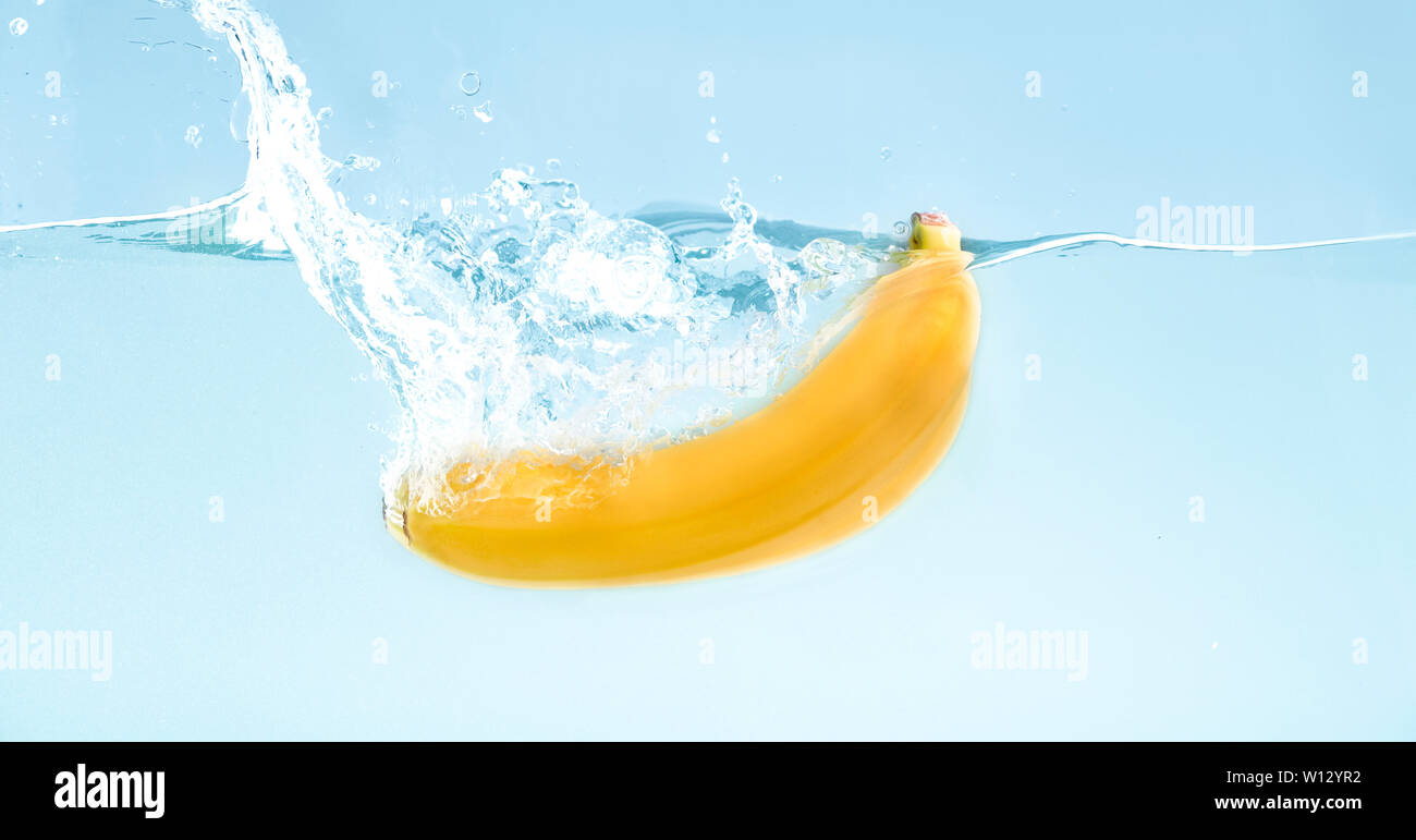 Banana falling under water with big splash Stock Photo - Alamy