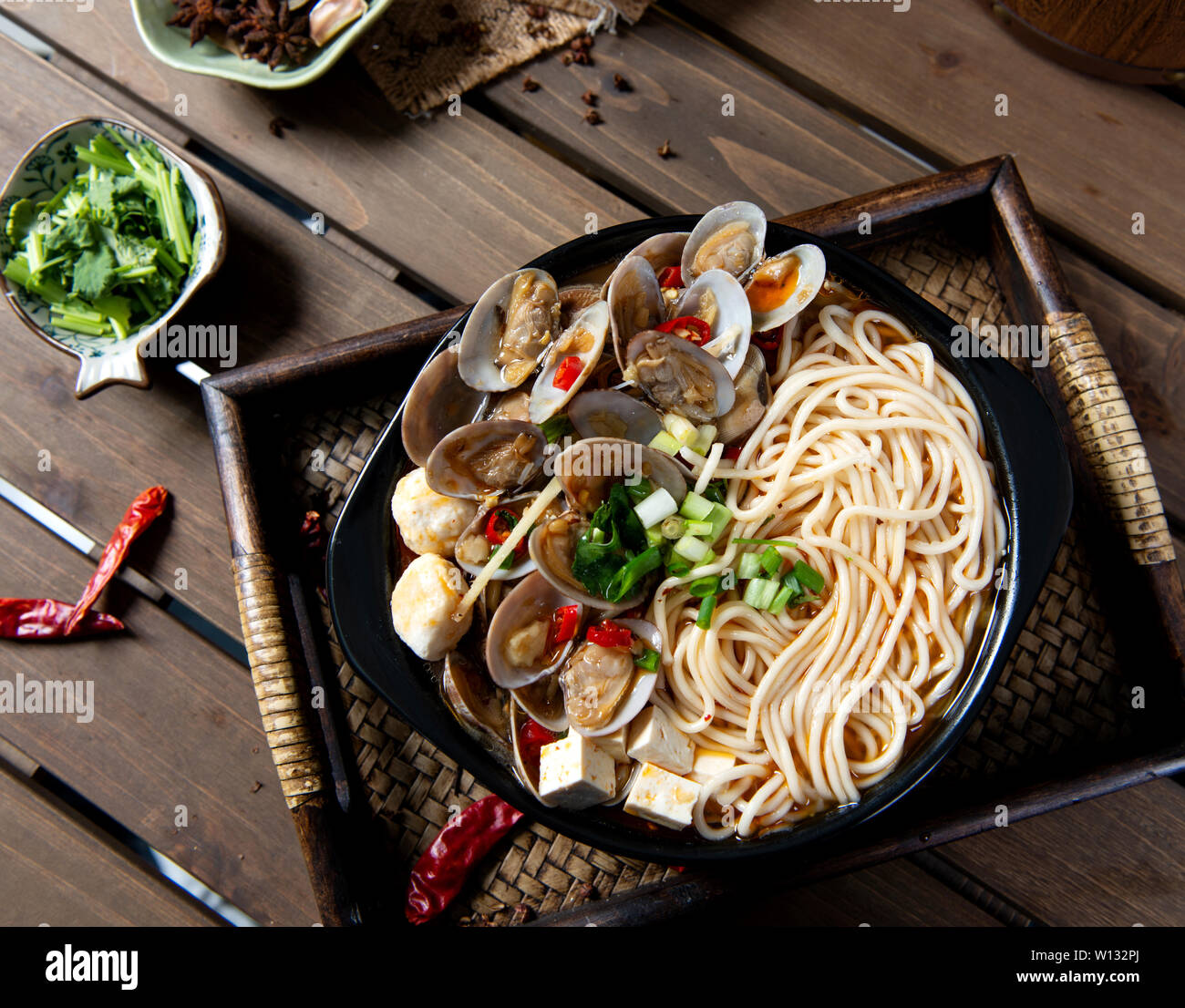 Golden soup, spicy flower armor, pink noodles Stock Photo - Alamy
