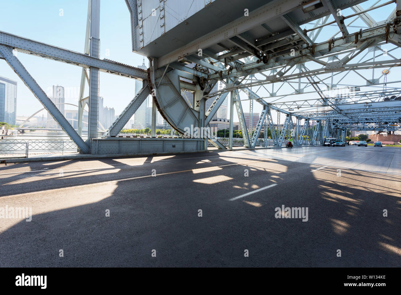 Traffic on steel bridge interior and skyline at sunset Stock Photo - Alamy
