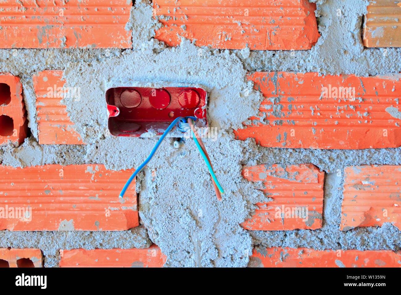 electricity wire construction in brick wall interior Construction site ...
