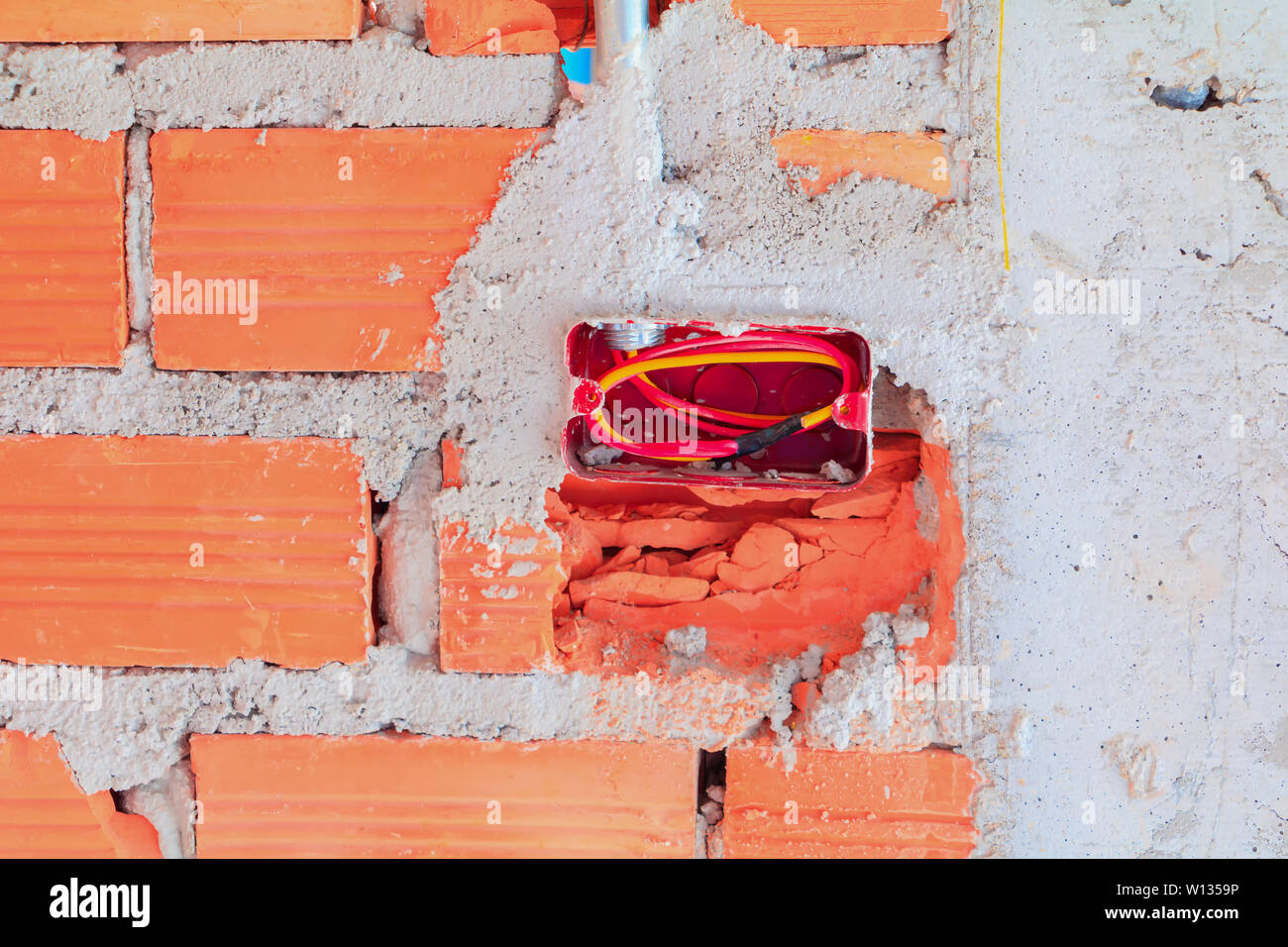 electricity wire construction in brick wall interior Construction site ...