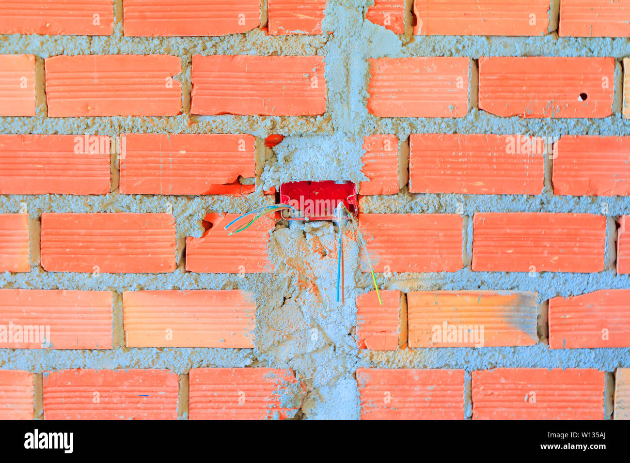 electricity wire construction in brick wall interior Construction site ...