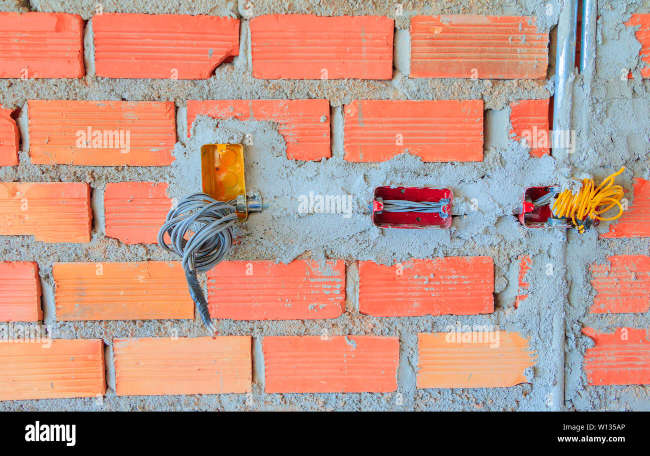 electricity wire construction in brick wall interior Construction site ...