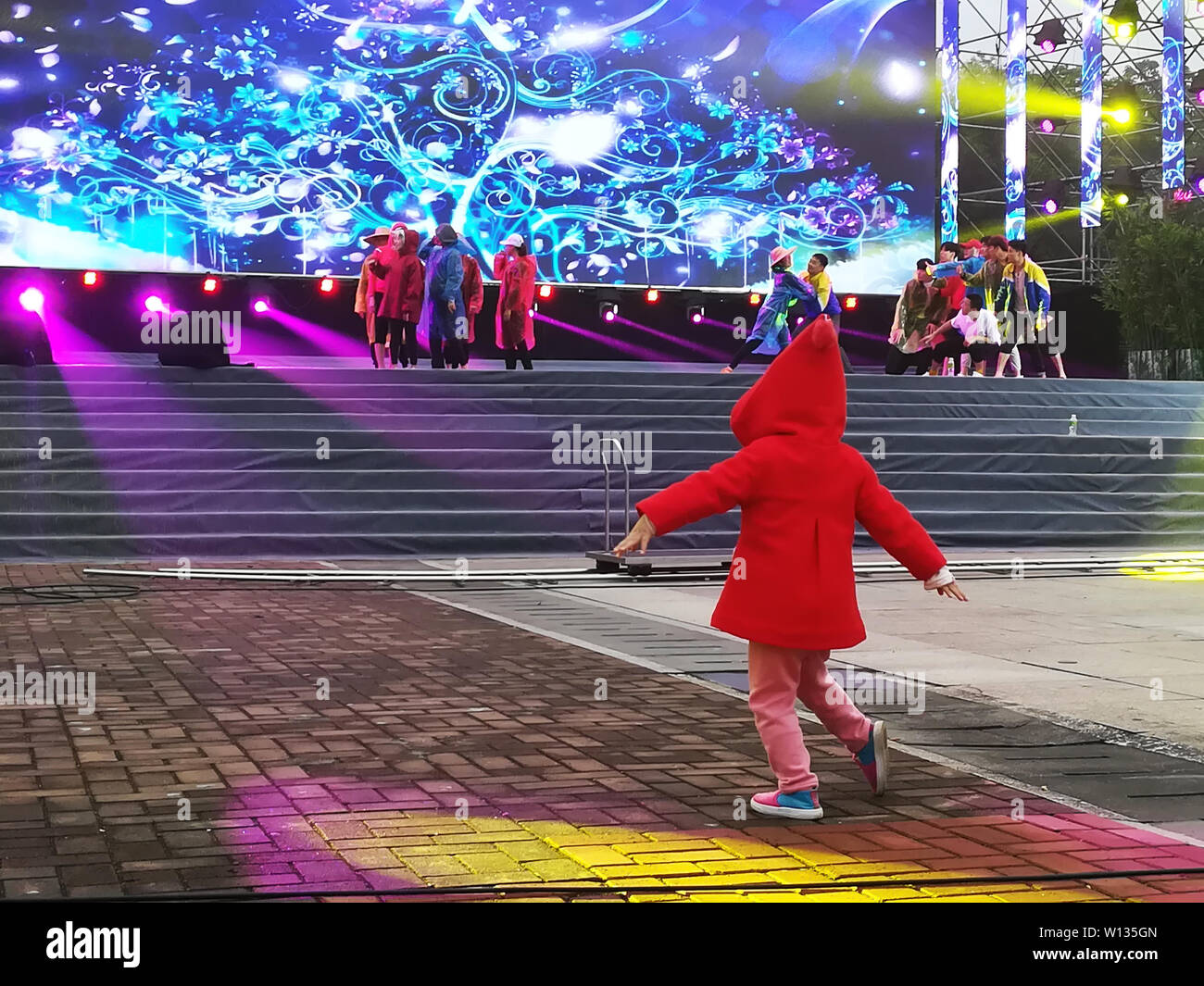 The little girl who mimics dancing under the stage Stock Photo - Alamy