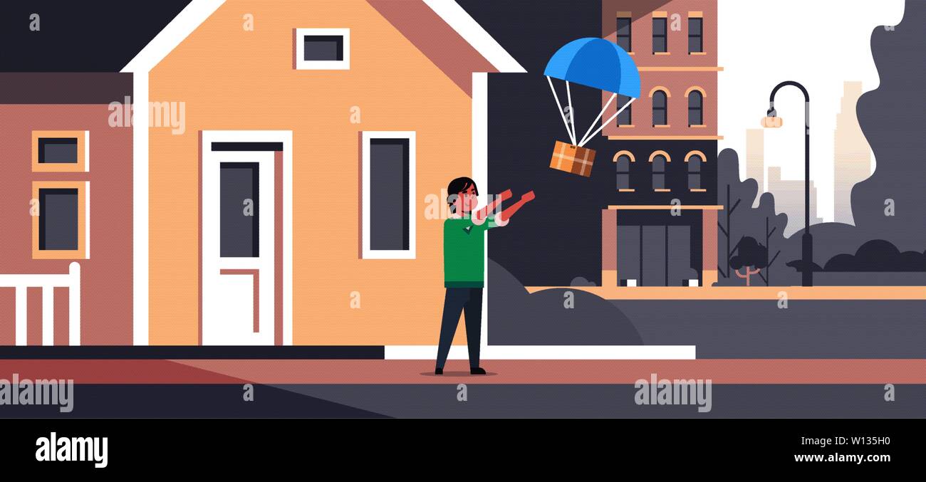 man catching parcel box falling down with parachute from sky ...