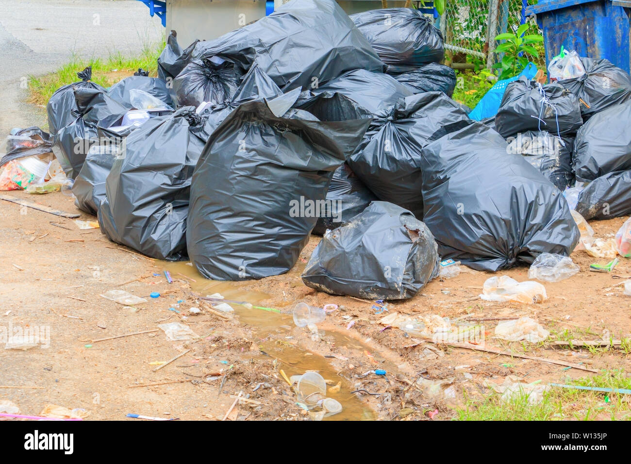 Pile garbage black bag plastic roadside in the city Stock Photo - Alamy