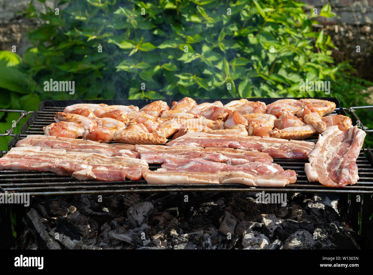 Close up picture of grilling tasty pork and chicken at an outdoor ...