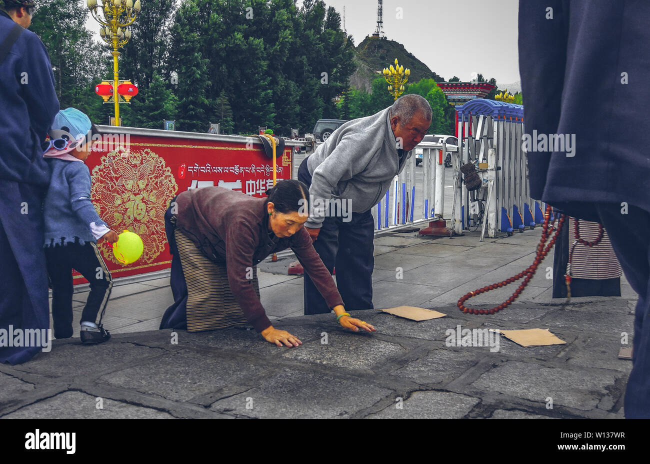 A devout believer in the streets of Lhasa Stock Photo - Alamy