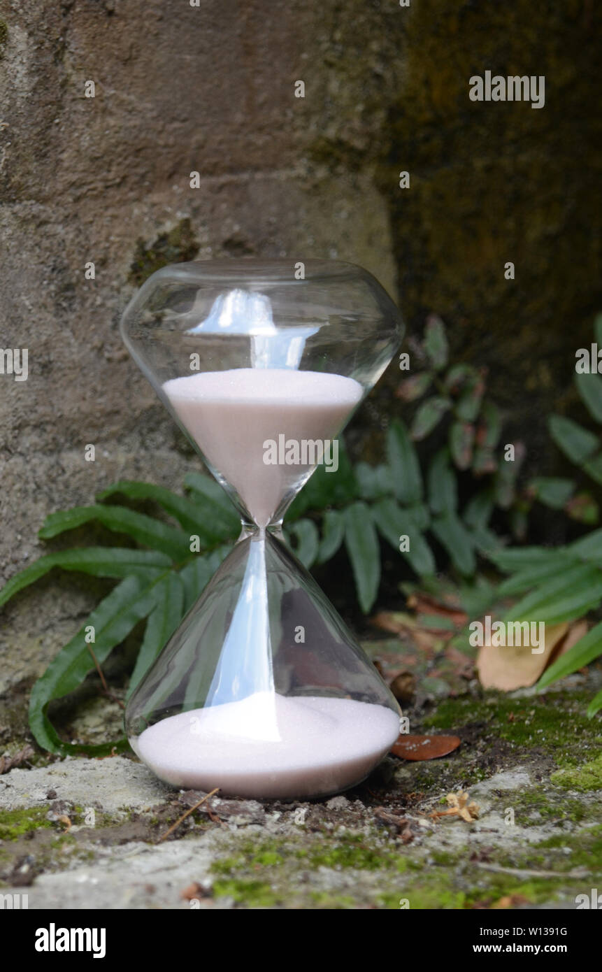 LOOPER An hourglass sits on a ledge to an opening of a old and historic ...