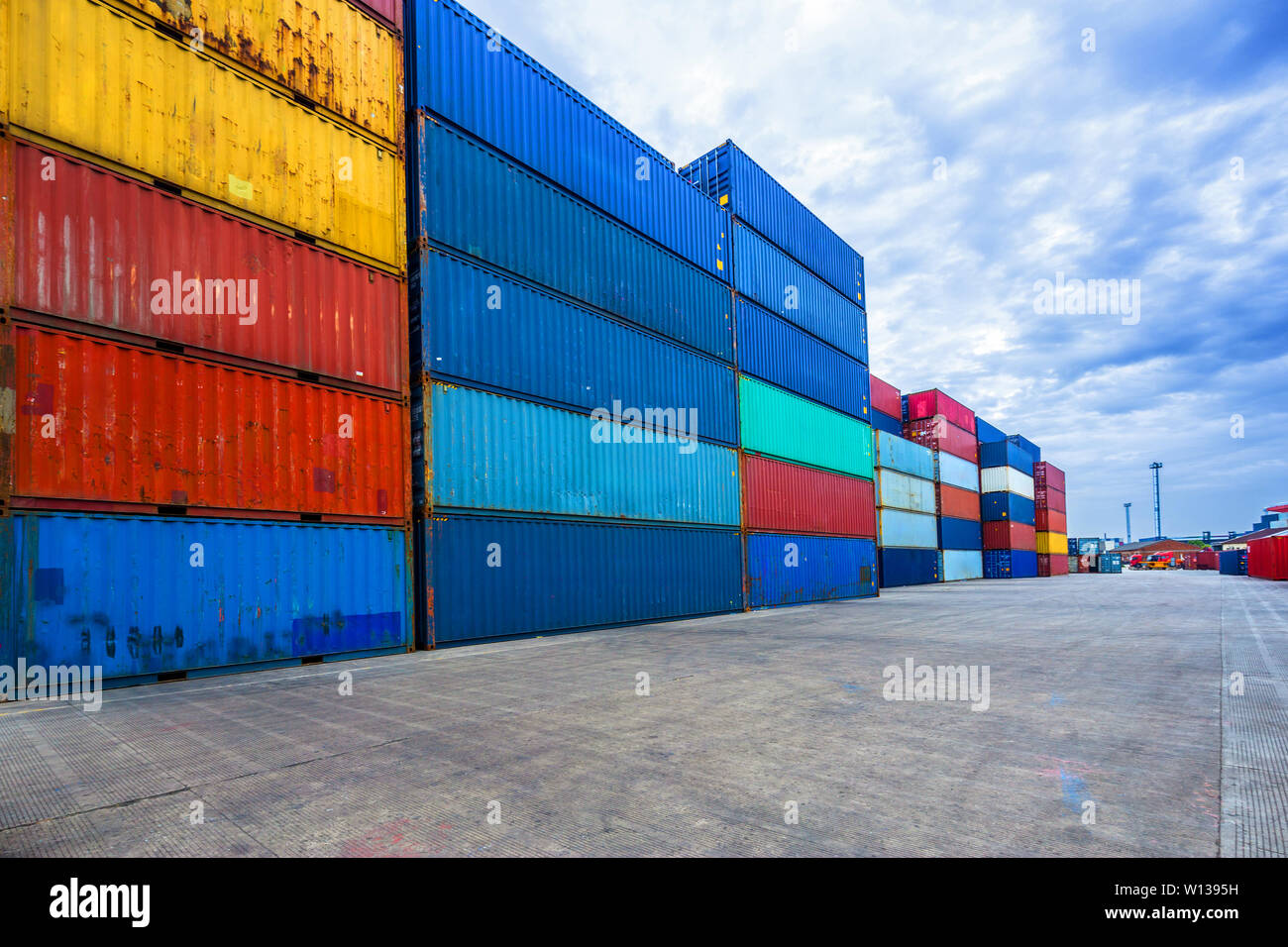 stack of containers with empty road in front Stock Photo - Alamy
