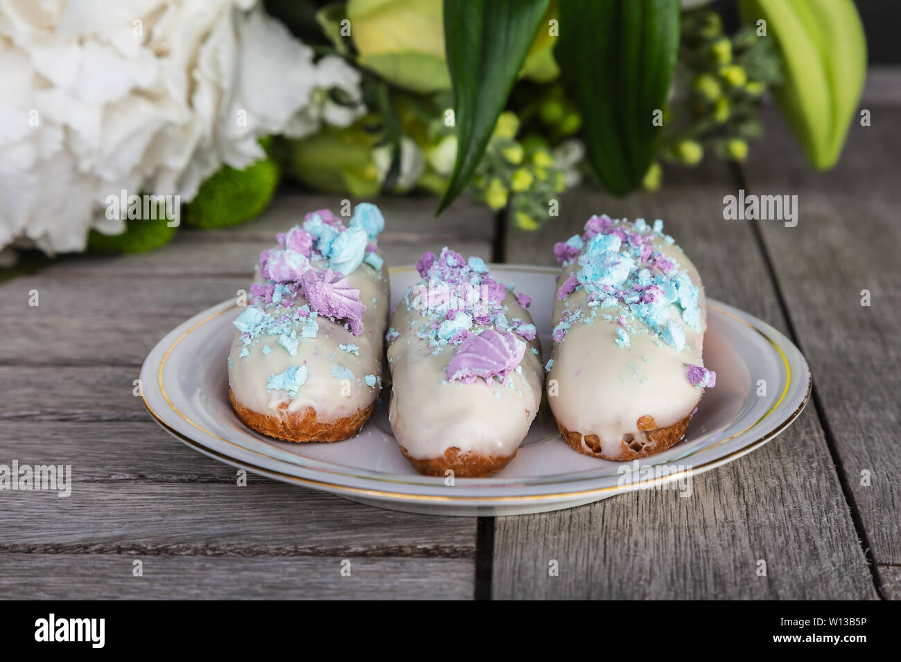Traditional french eclairs is typically piped into an oblong shape with ...