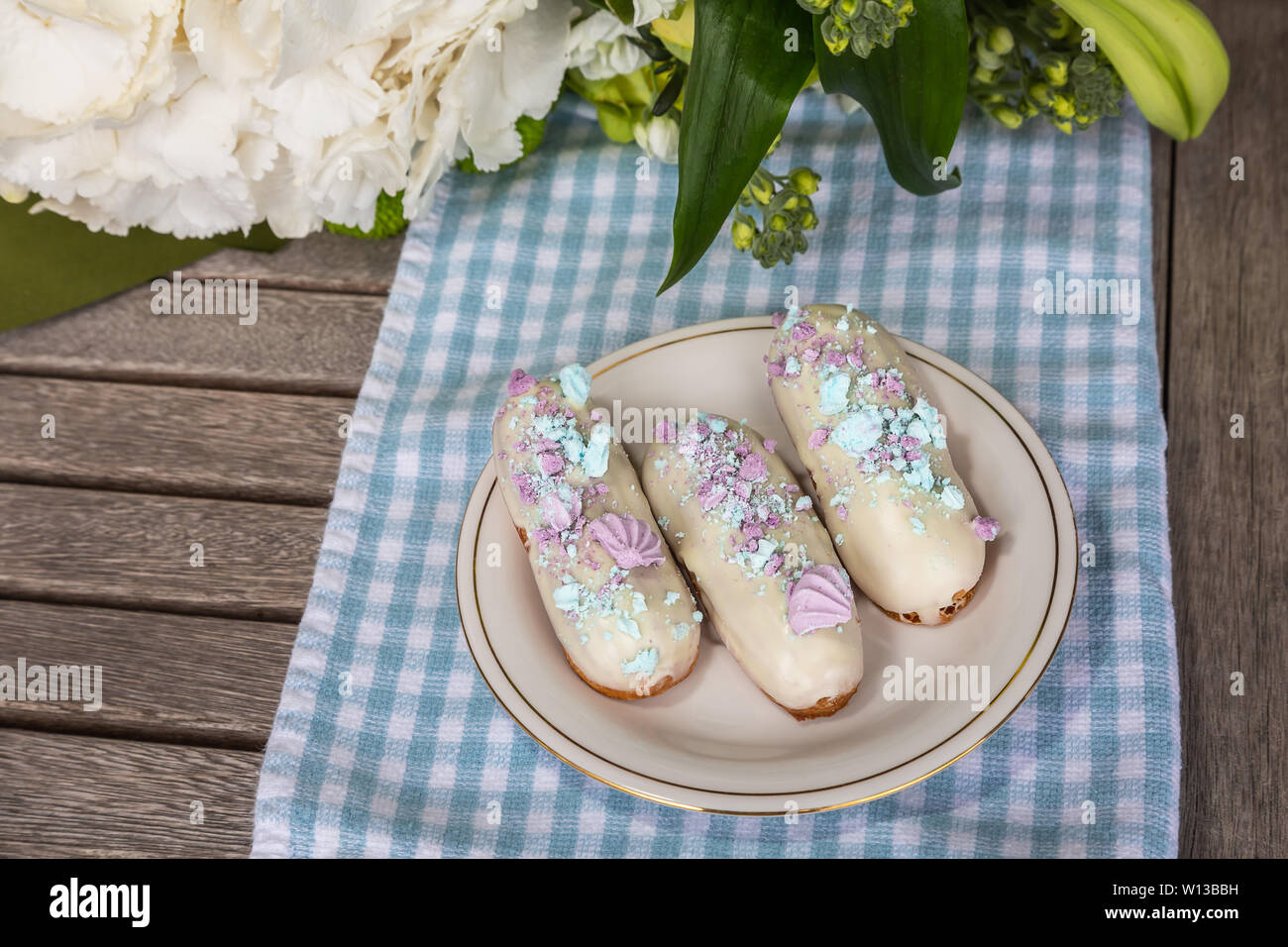 Traditional french eclairs is typically piped into an oblong shape with ...