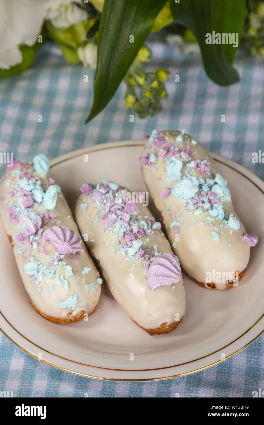 Traditional french eclairs is typically piped into an oblong shape with ...
