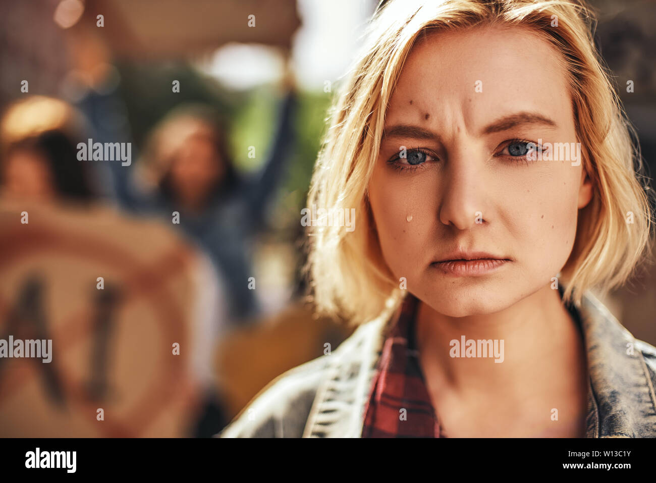 Worry about my planet. Close up portrait of sad female activist crying ...
