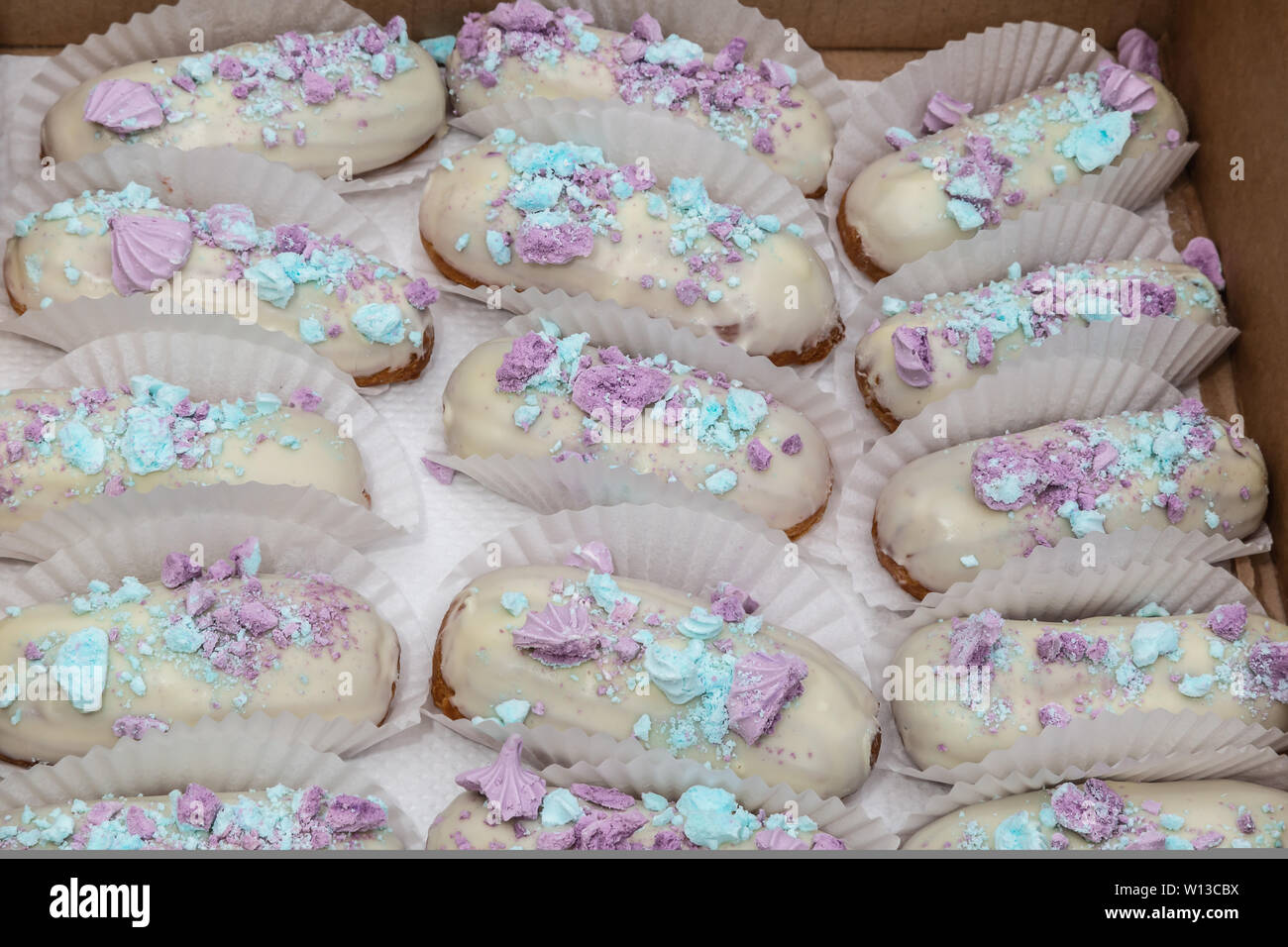 Traditional french eclairs is typically piped into an oblong shape with ...