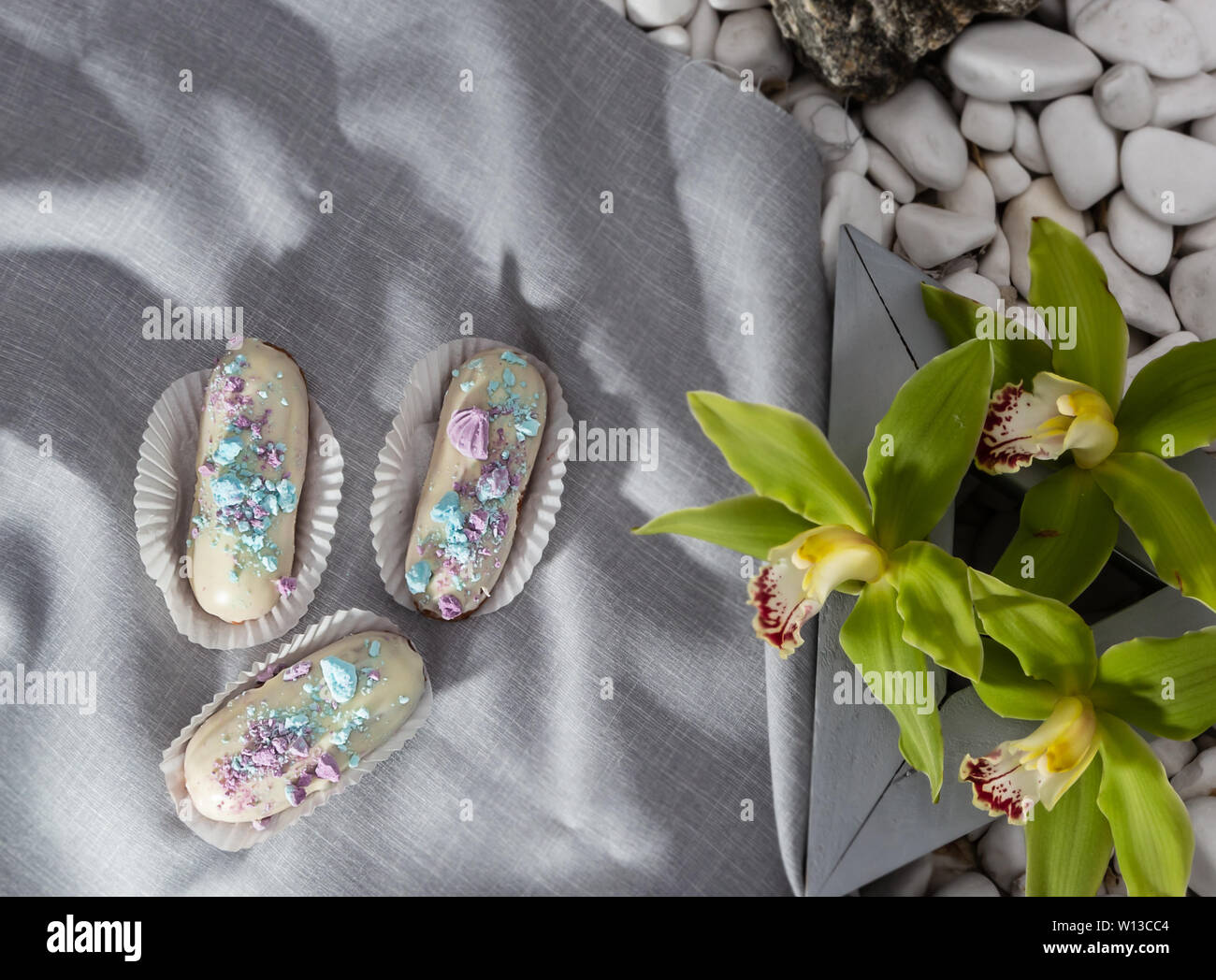 Traditional french eclairs is typically piped into an oblong shape with ...