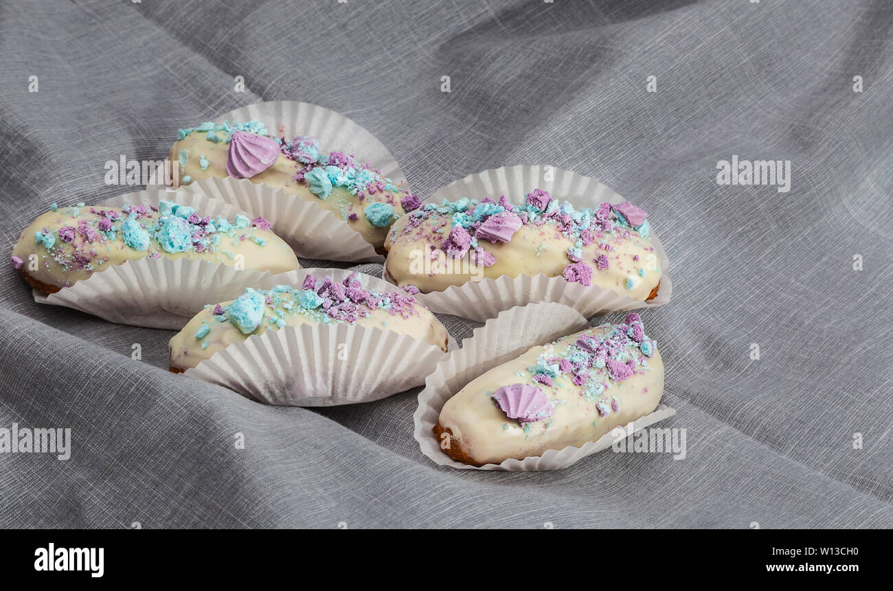 Traditional french eclairs is typically piped into an oblong shape with ...