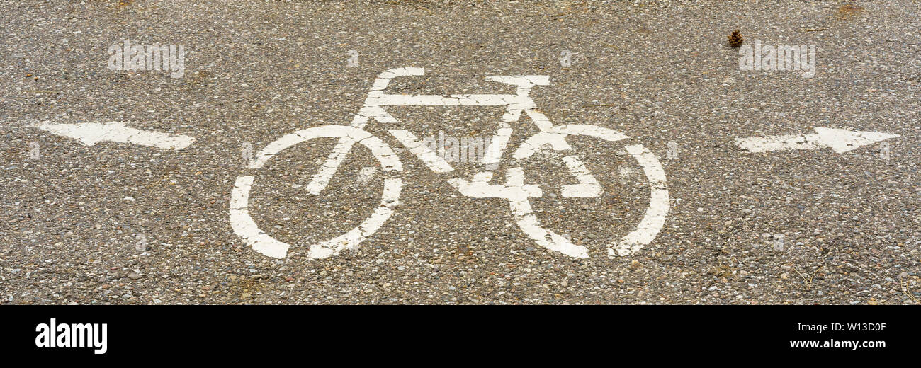 Bicycle symbol on a bike path from tar with directional information ...
