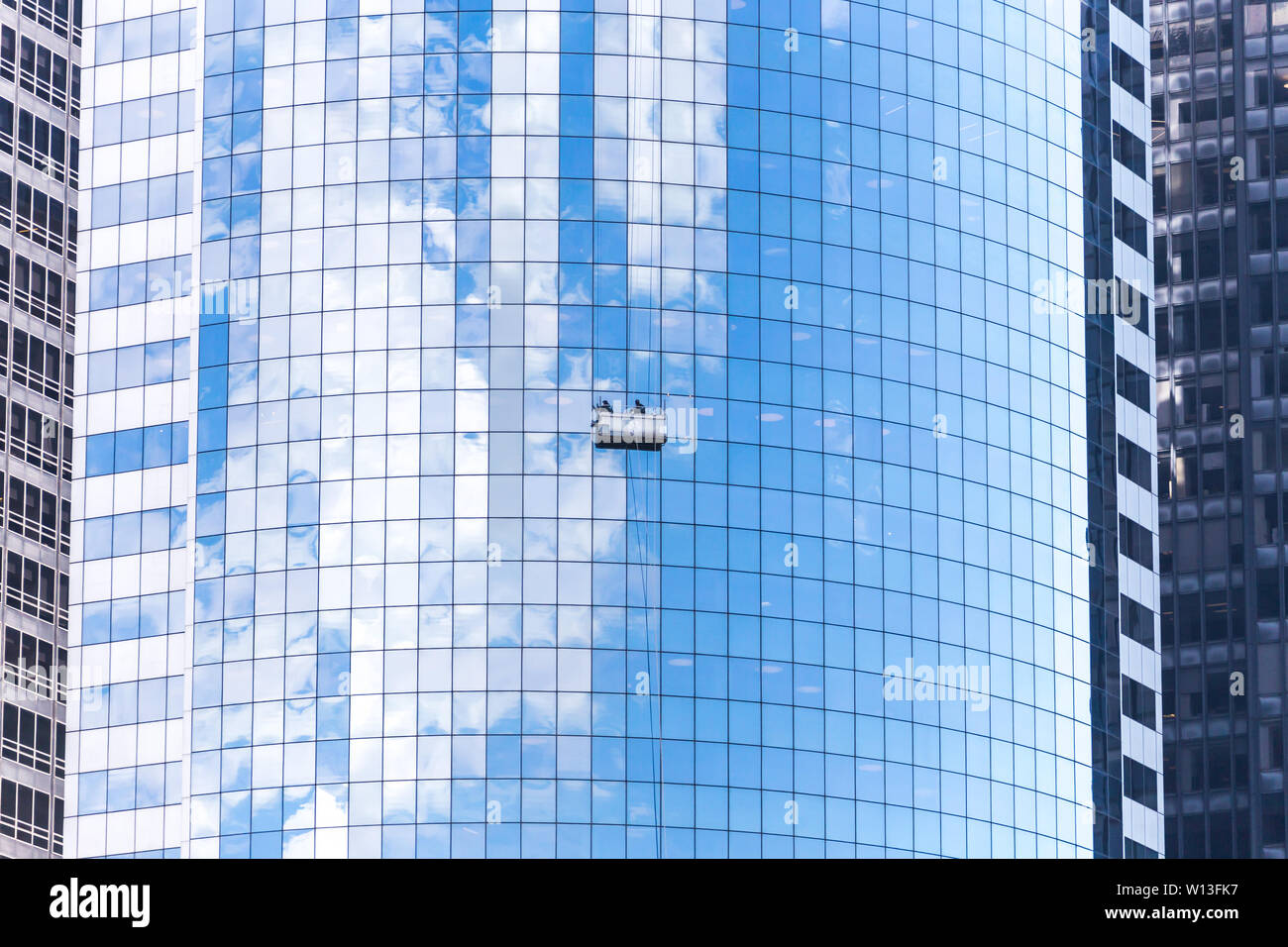 NEW YORK, USA - 16 MAY, 2019: Two cleaners washing the windows of ...