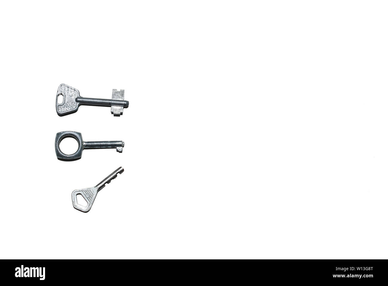 Three old different keys isolated on the white background with copy ...