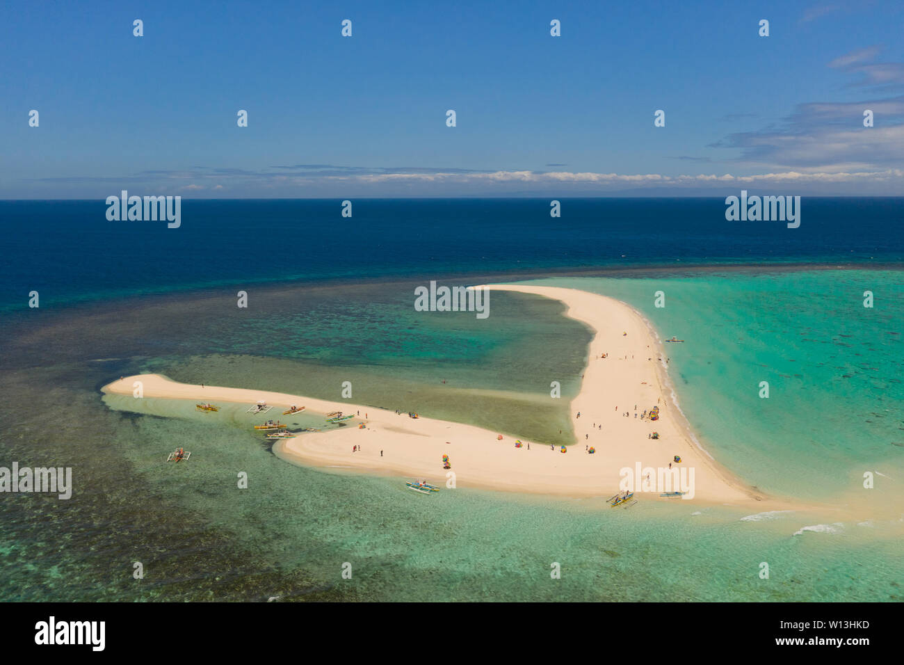 Atoll with an island of white sand. Sand beach island on a coral reef ...