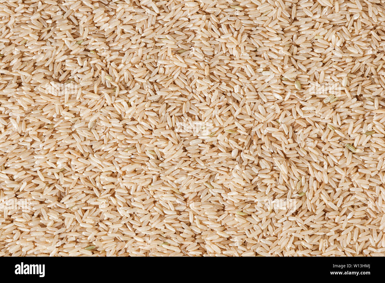 Uncooked brown rice background Stock Photo - Alamy