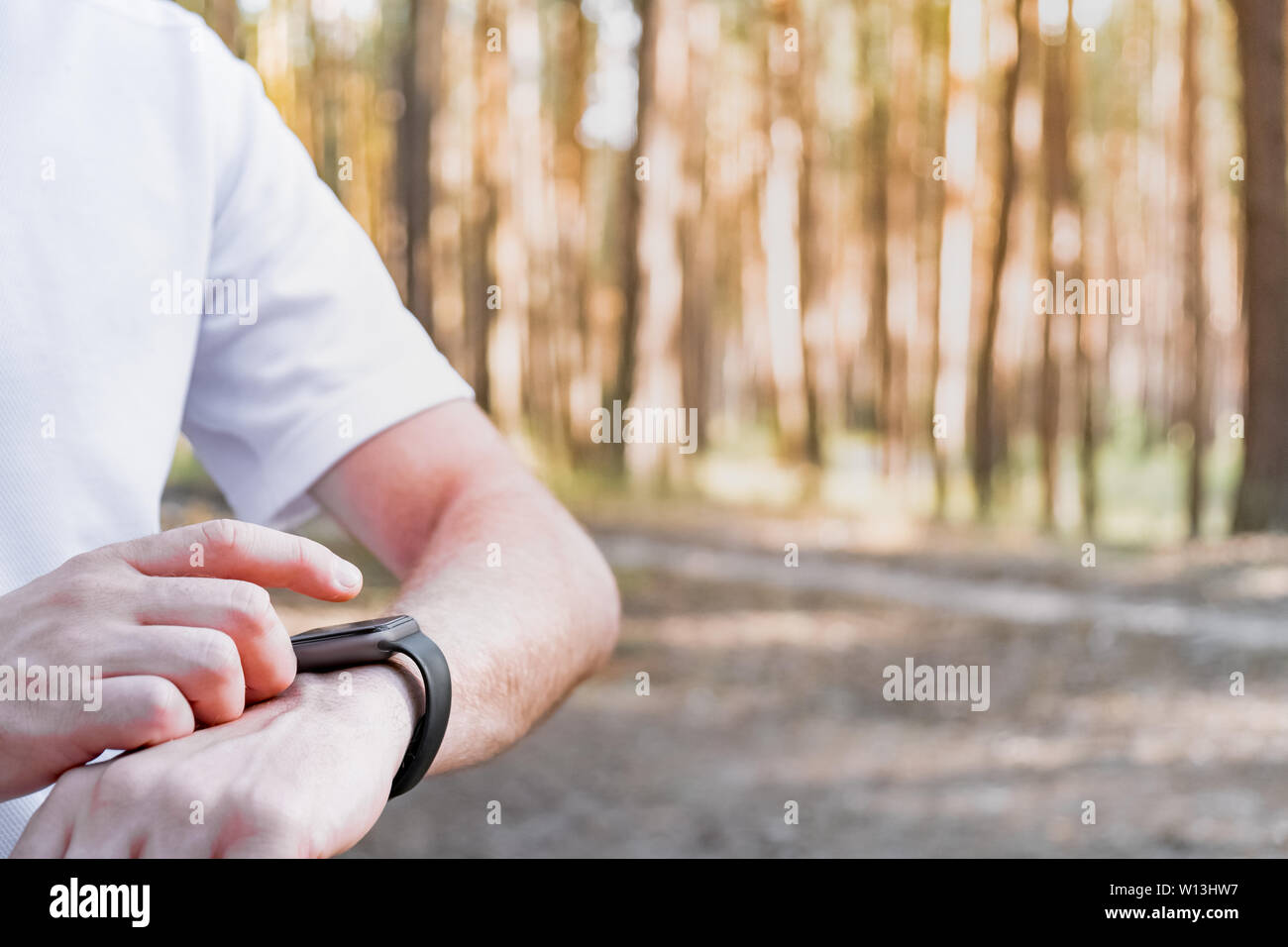 Using smart watch outdoors for walking or jogging. Close-up of human ...