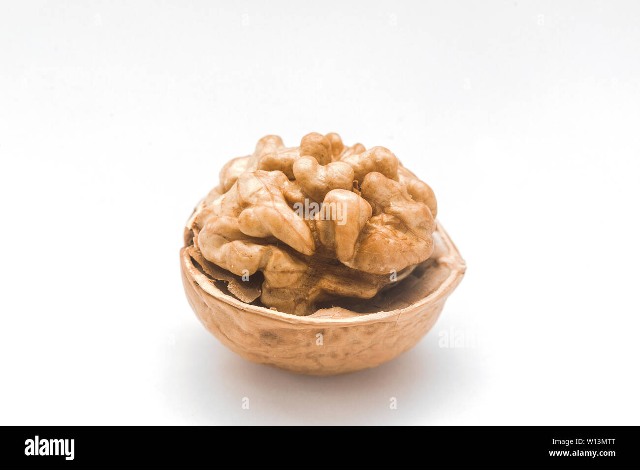 A complete walnut kernel isolated on a white background Stock Photo - Alamy