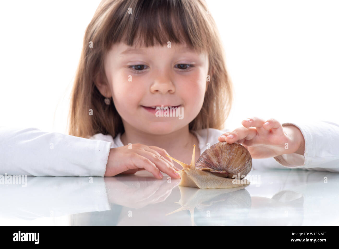 Cute little girl and Akhatina snail. Close up. Concept of youth and ...