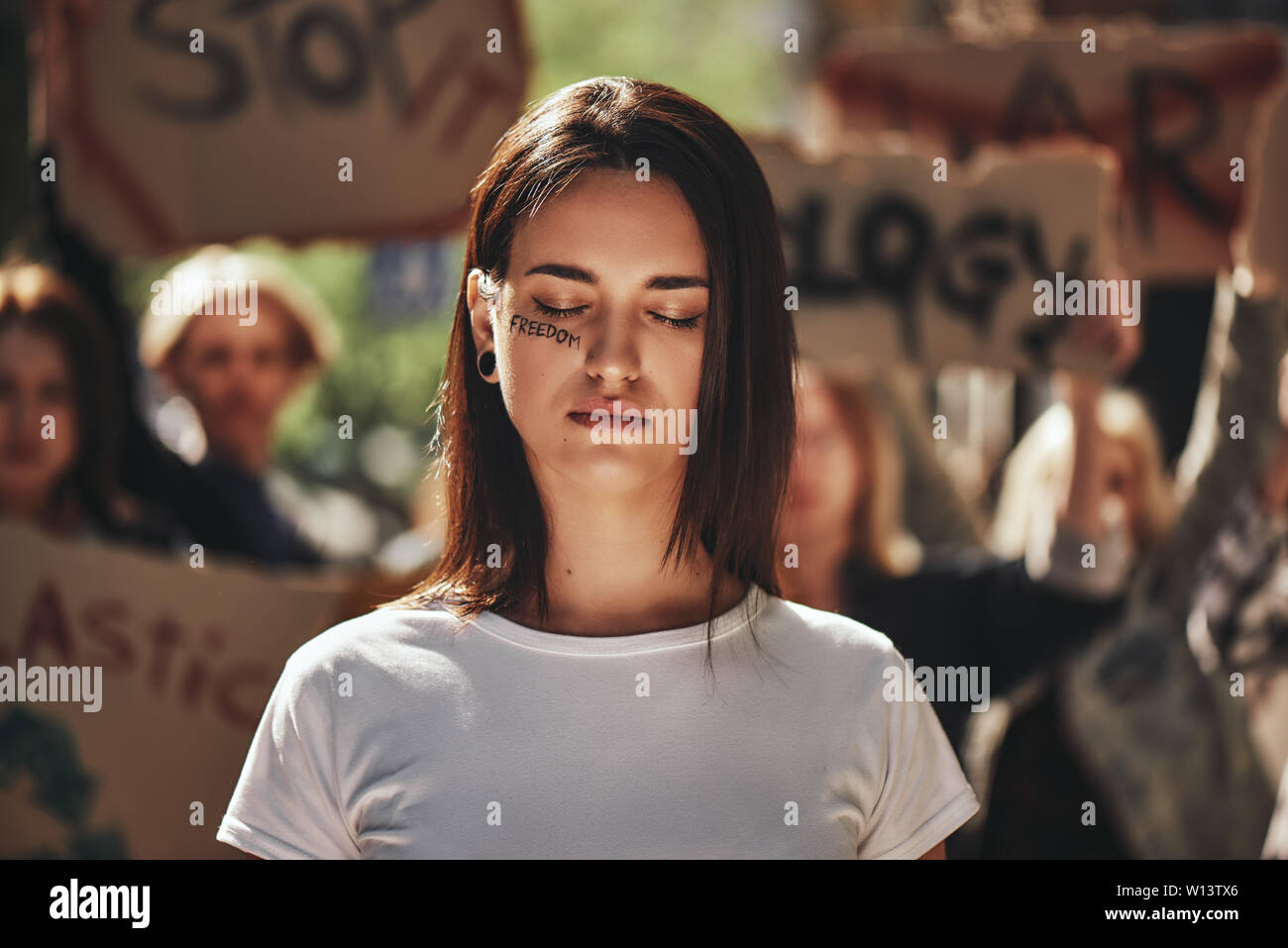 Fighting for clean planet. Young activist with word freedom written on ...