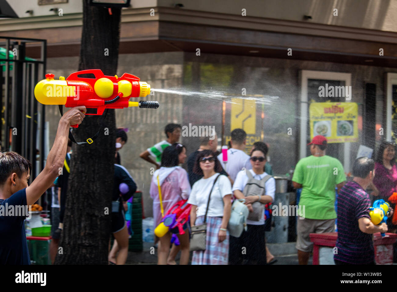 Bangkok, Thailand - April 12, 2019: Crowd throwing water on the street ...