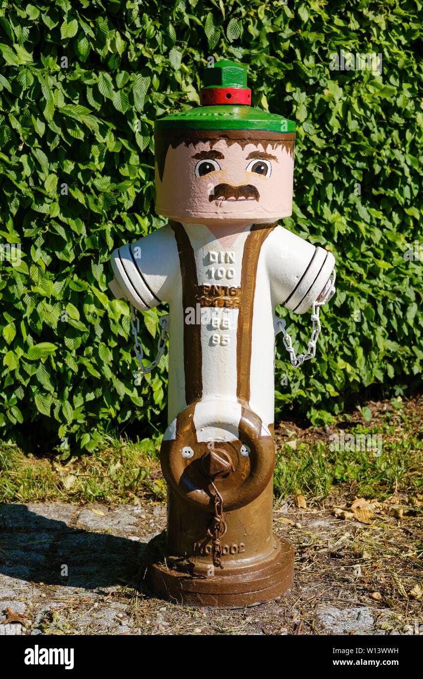 Painted hydrant in bavarian traditional costume hi-res stock ...