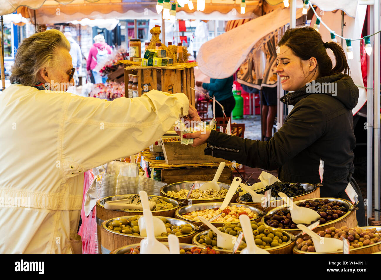 French olive market stall in English town square with mature male ...