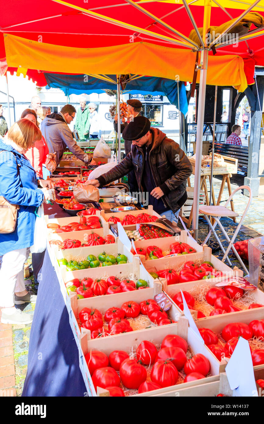 French green grocer market stall in cobbled town square with mature ...