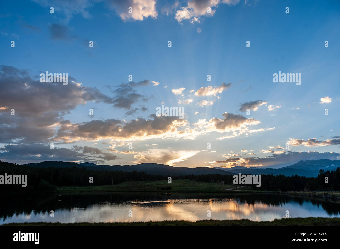 Sunset over a small Lake in the Colorado Rocky Mountains, known as Los ...