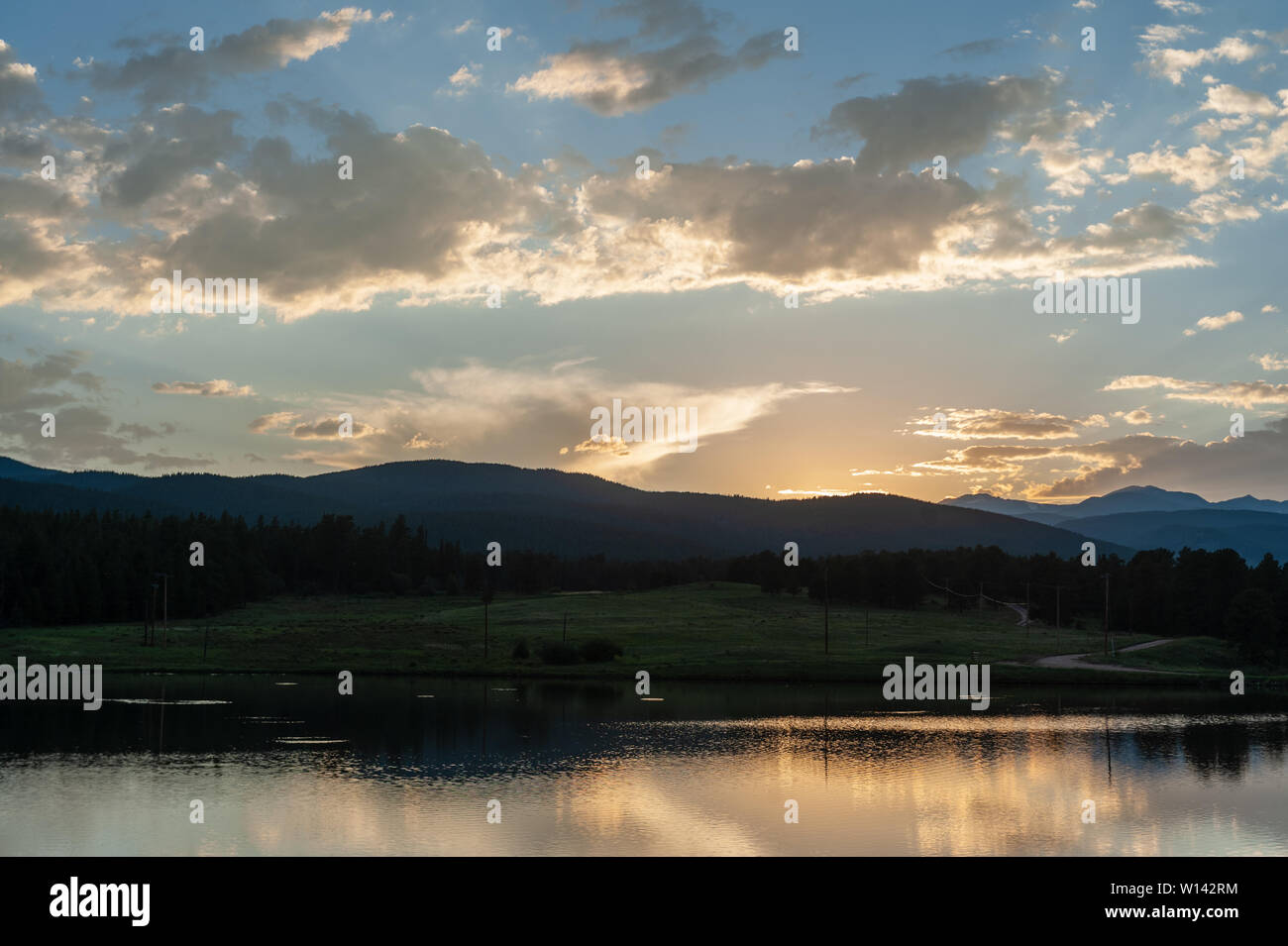 Sunset over a small Lake in the Colorado Rocky Mountains, known as Los ...