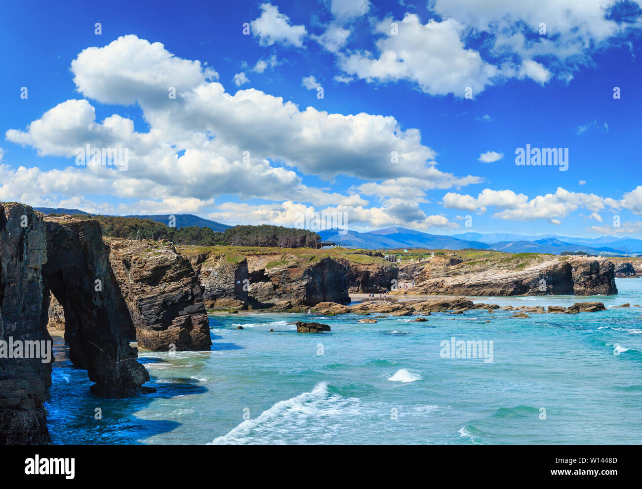 Natural rock arches on As Catedrais beach in low tide (Cantabric coast ...