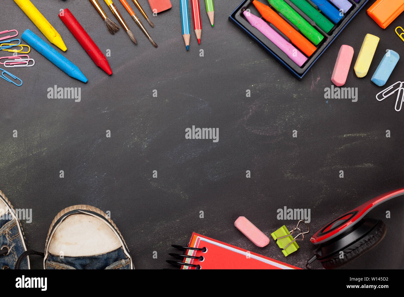 School education supplies on chalkboard backdrop. Back to school ...