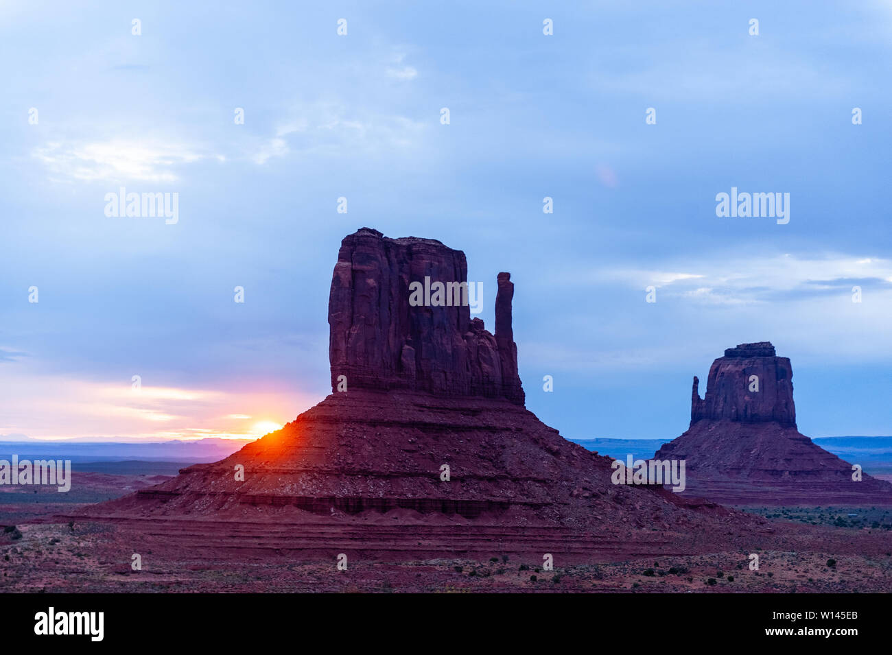 Sunrise over the famous mitten and merrick buttes of Monument Valley ...