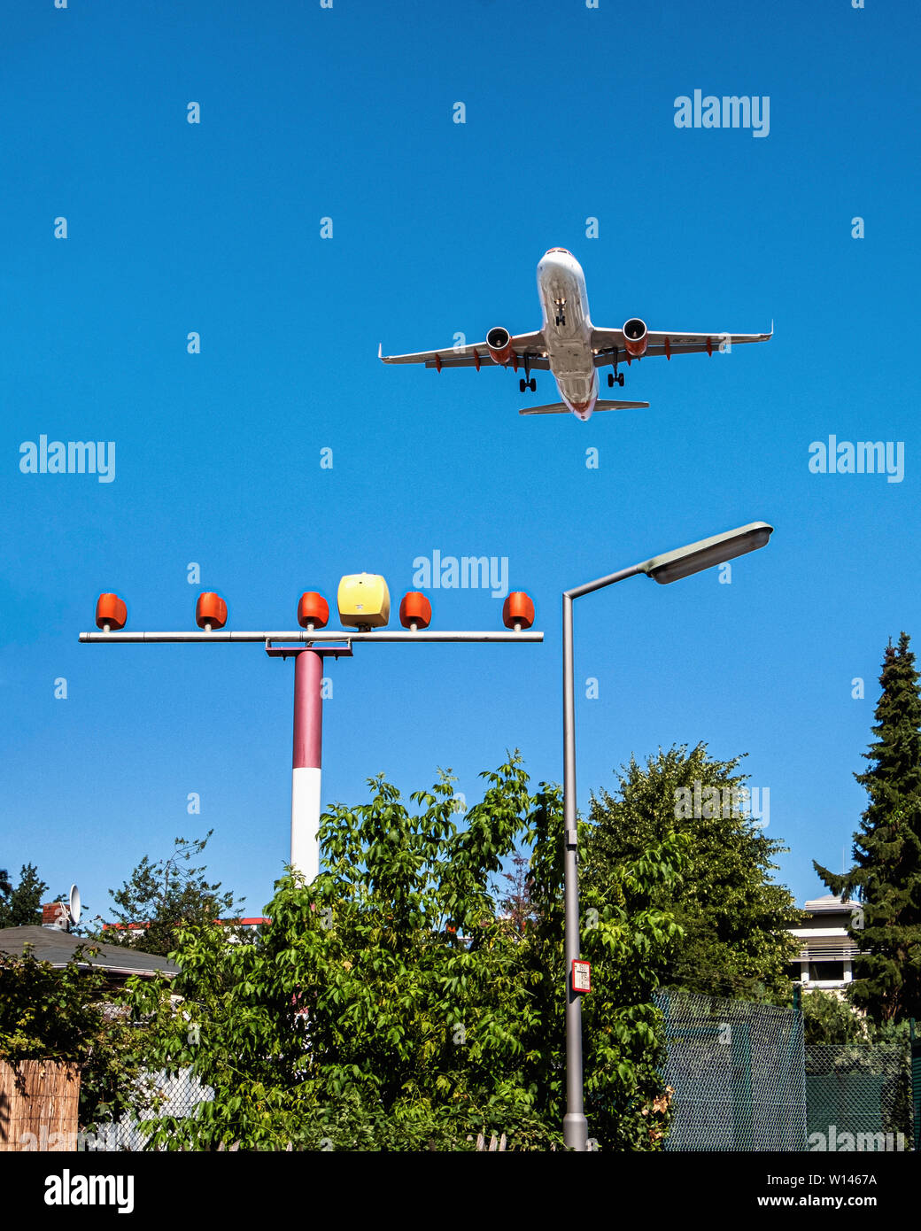 Easy jet plane with flight path lights in Suburban garden. Aeroplane ...