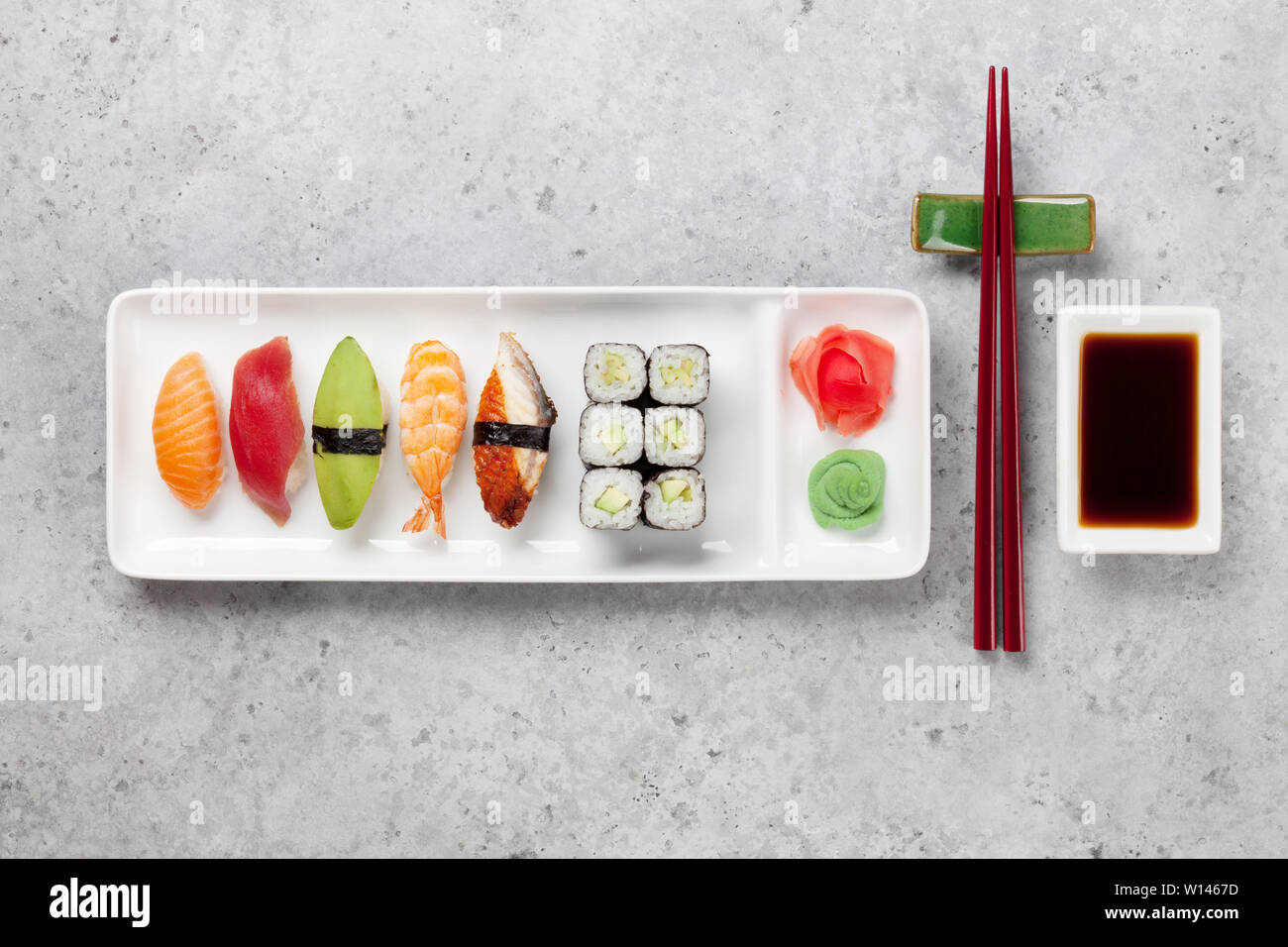 Japanese sushi set. Sashimi, maki rolls. On plate over stone background ...