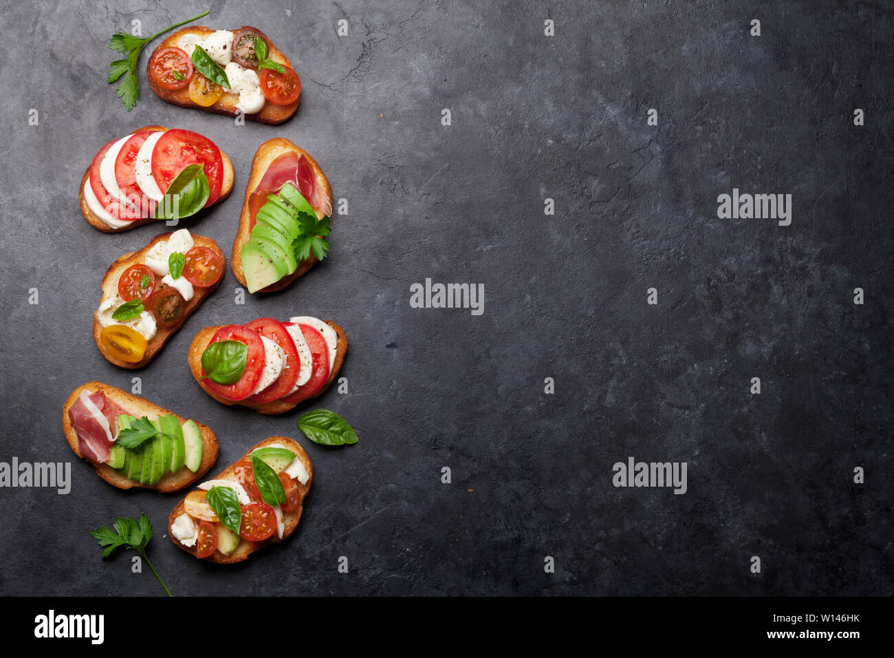 Traditional spanish tapas with tomatoes, mozzarella cheese, avocado and ...