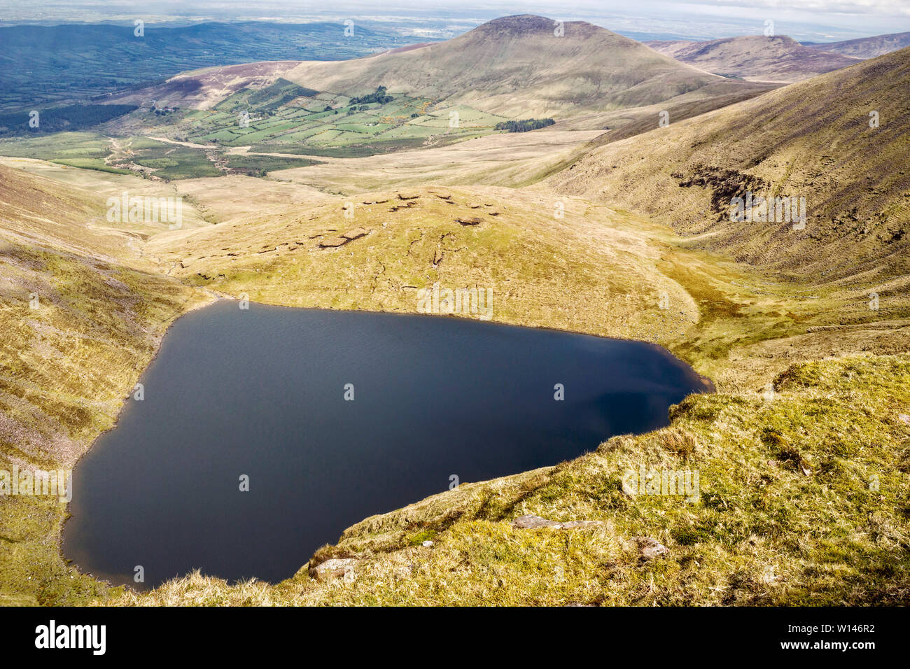 Panorama of Lough Curra nestled at the foot of Galtymore Mountain ...