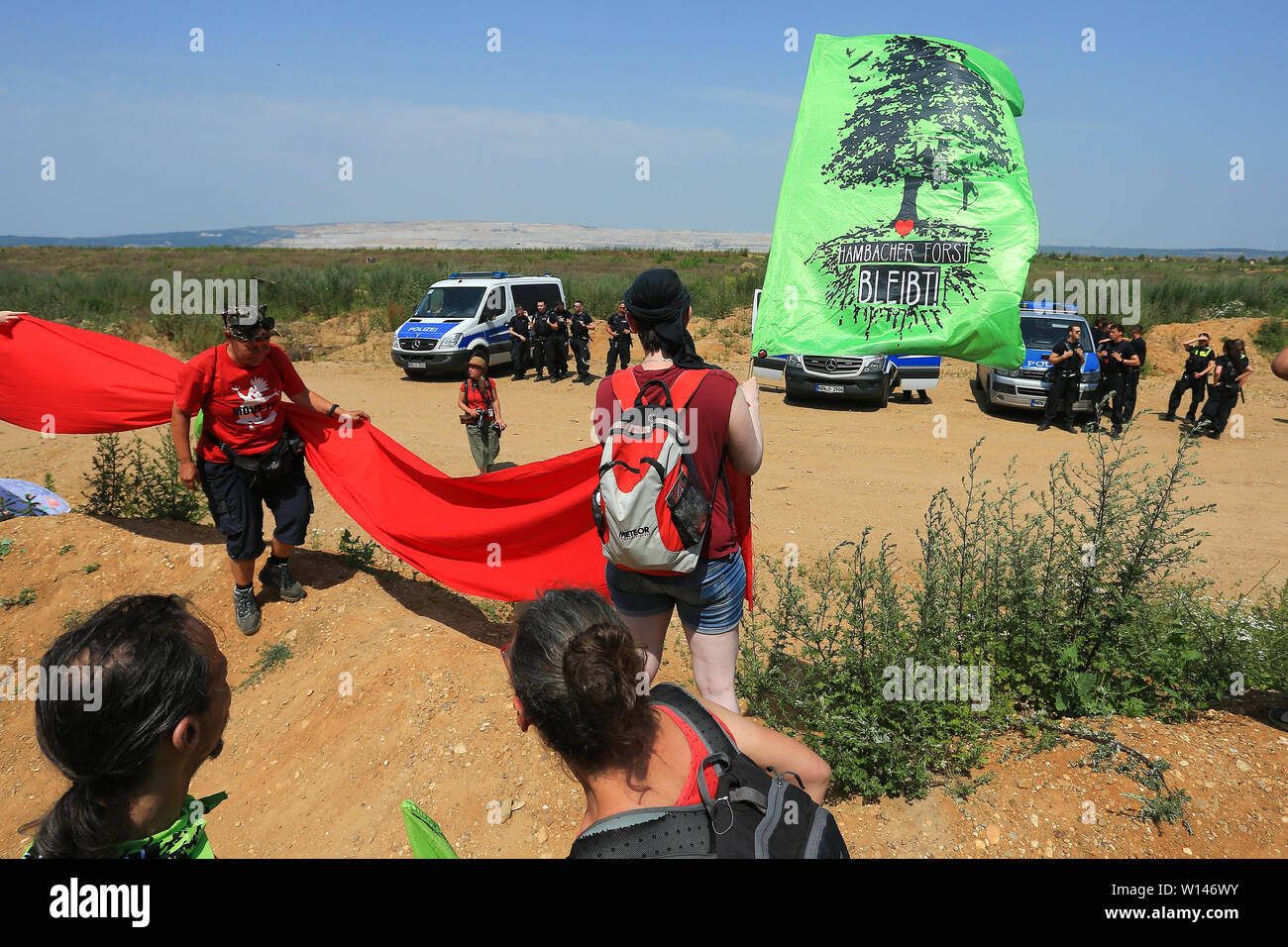 Kerpen, Germany. 30th June, 2019. Demonstrators form a protest line, a ...