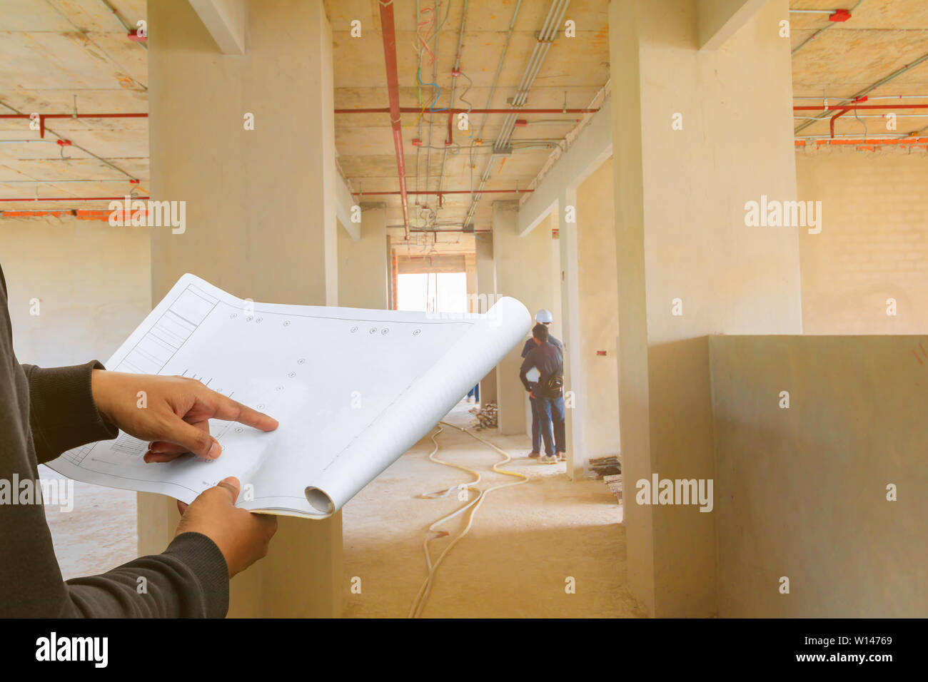 engineer finger point on paper plan blueprint in check building ...