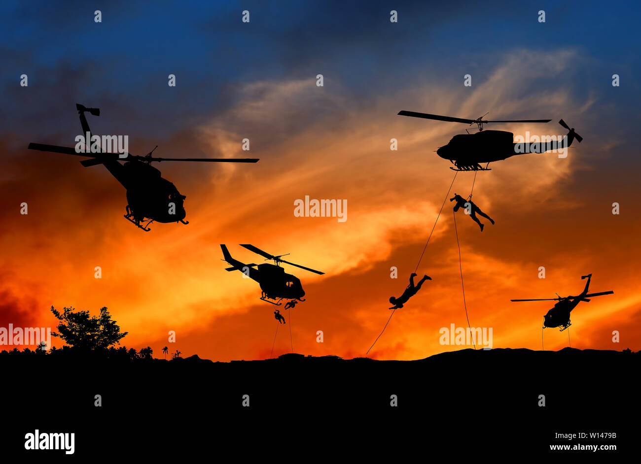 Silhouette Soldiers rappel down to attack from helicopter with sunset ...