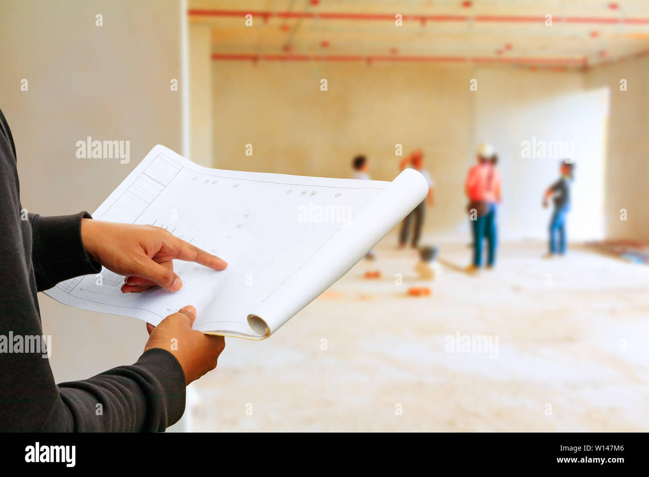 engineer finger point on paper plan blueprint in check building ...