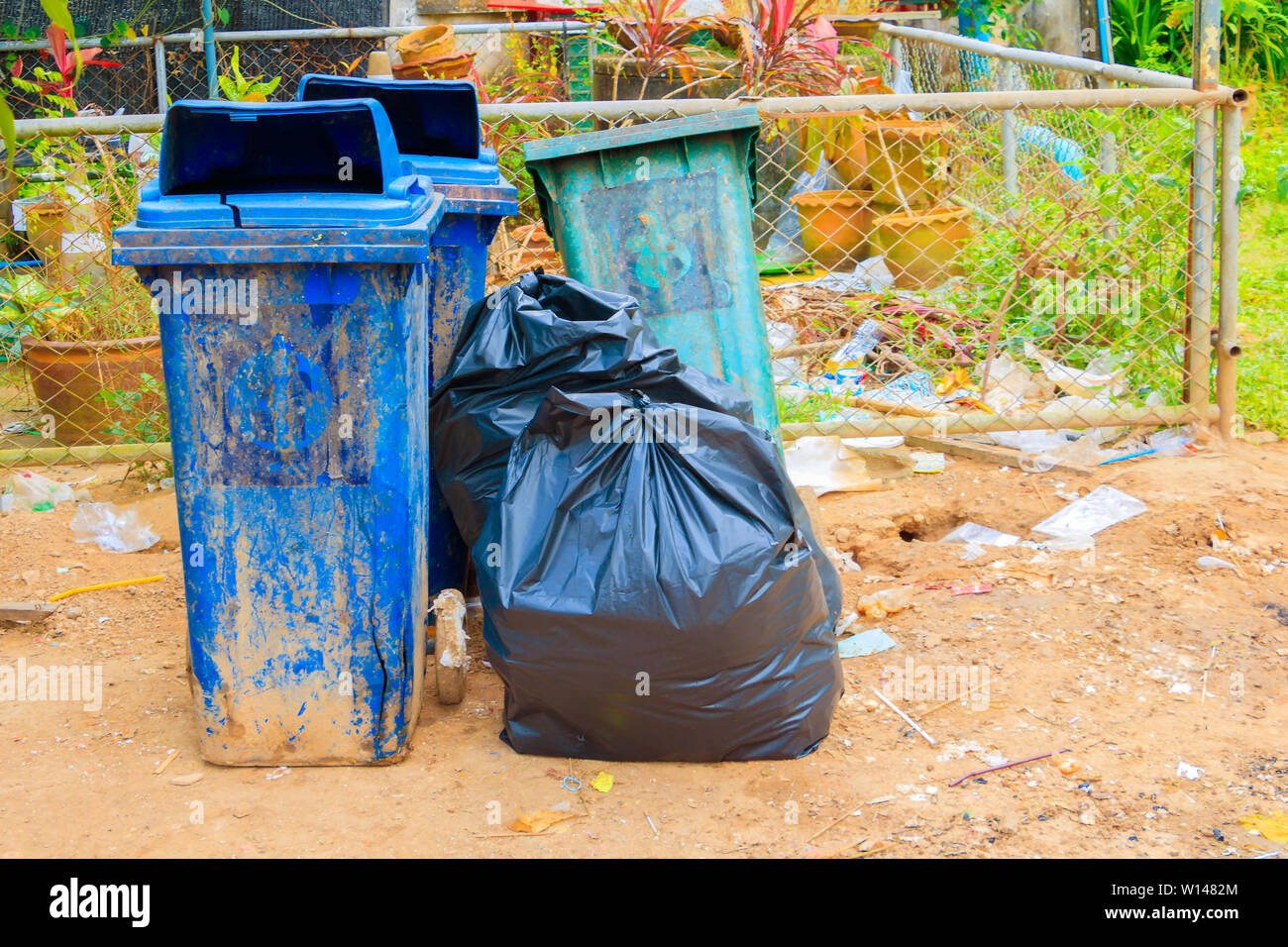 pile black garbage bag plastic and four dustbin dirty roadside in the ...