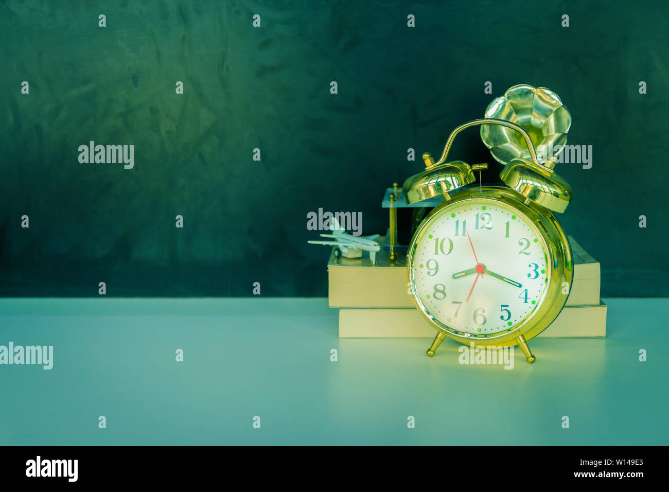 alarm clock old vintage gold and book - plane plastic. over white on ...