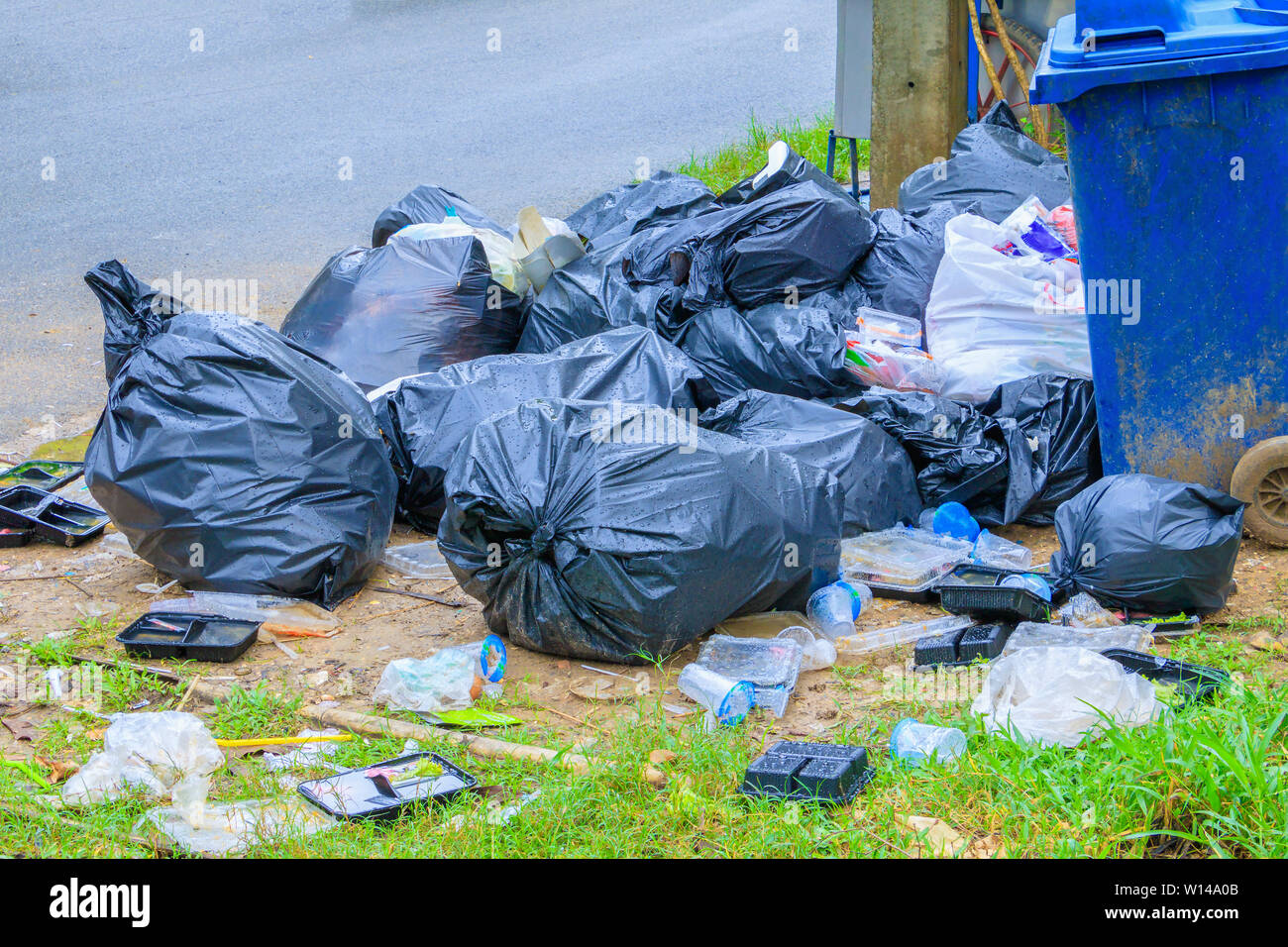 Pile black garbage roadside and Rain drops on the bag in the city with ...